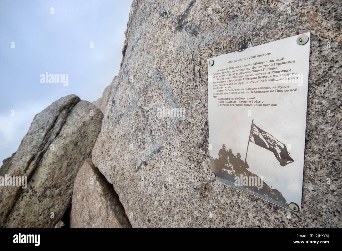 Commemorative plaque on the mountain peak Kumbel in Almaty mountains ...
