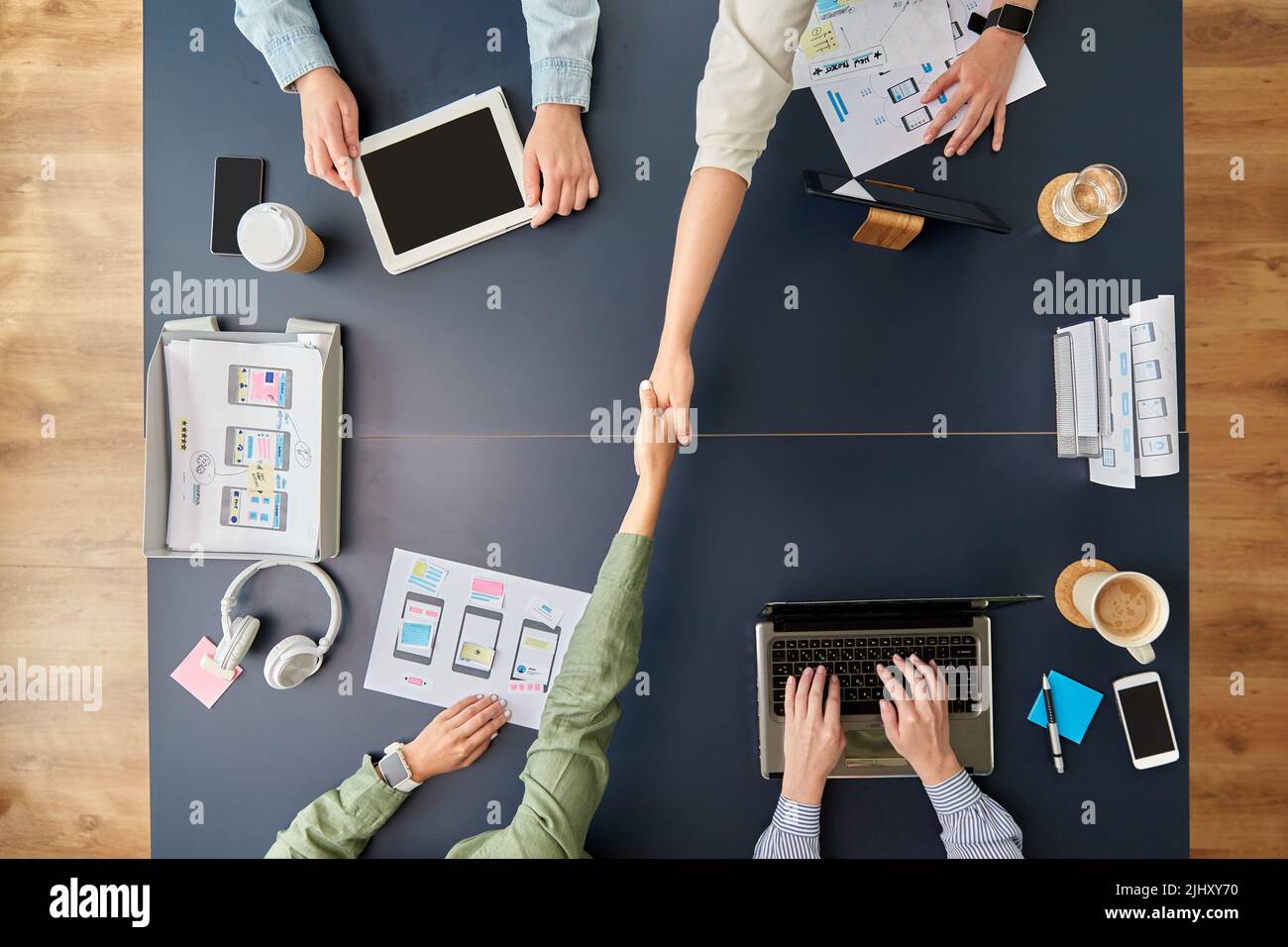 business team makes handshake at office table Stock Photo - Alamy