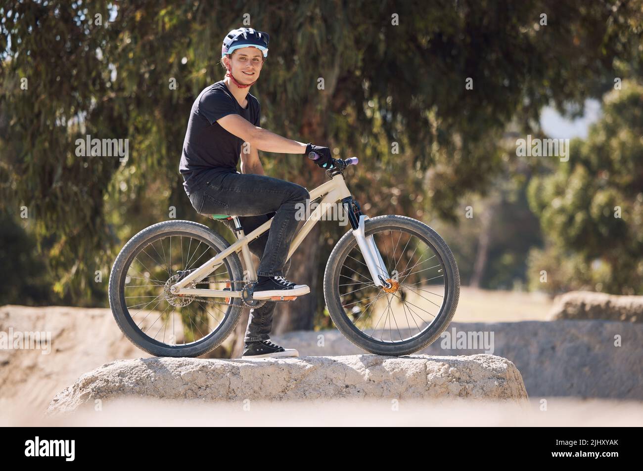 Portrait of a handsome man wearing a helmet and taking a break from ...