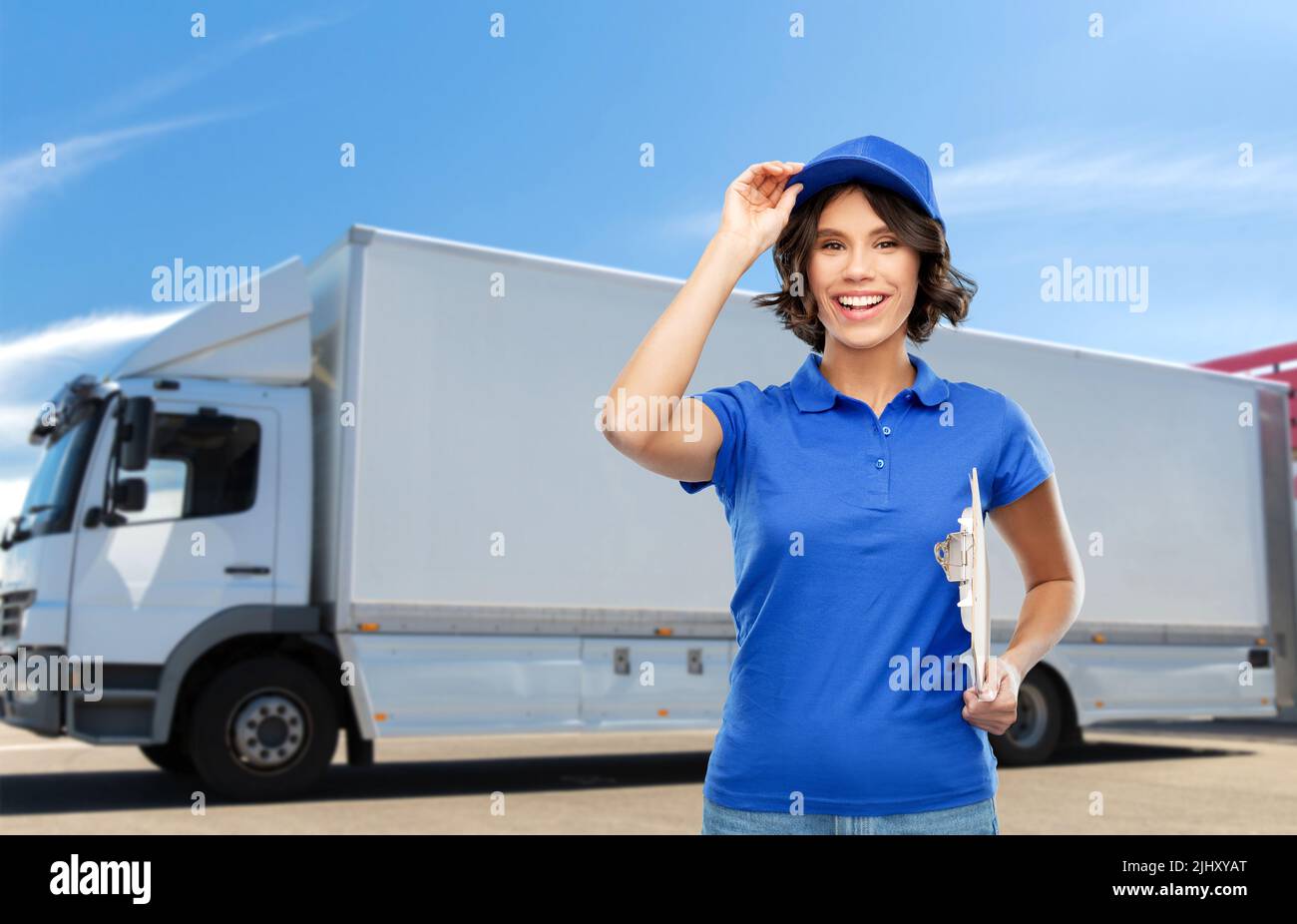 happy delivery girl with clipboard and pen writing Stock Photo - Alamy