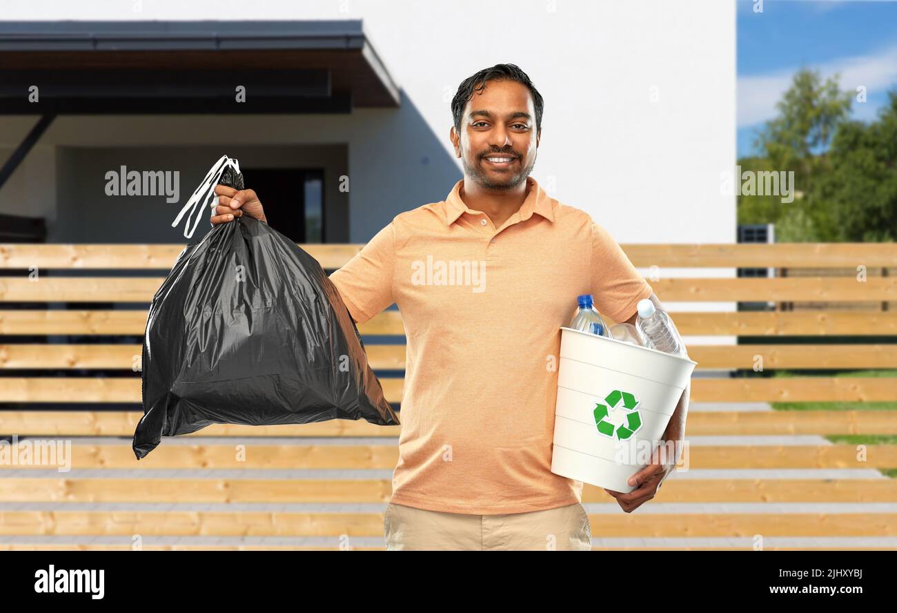 smiling indian man sorting paper and plastic waste Stock Photo - Alamy