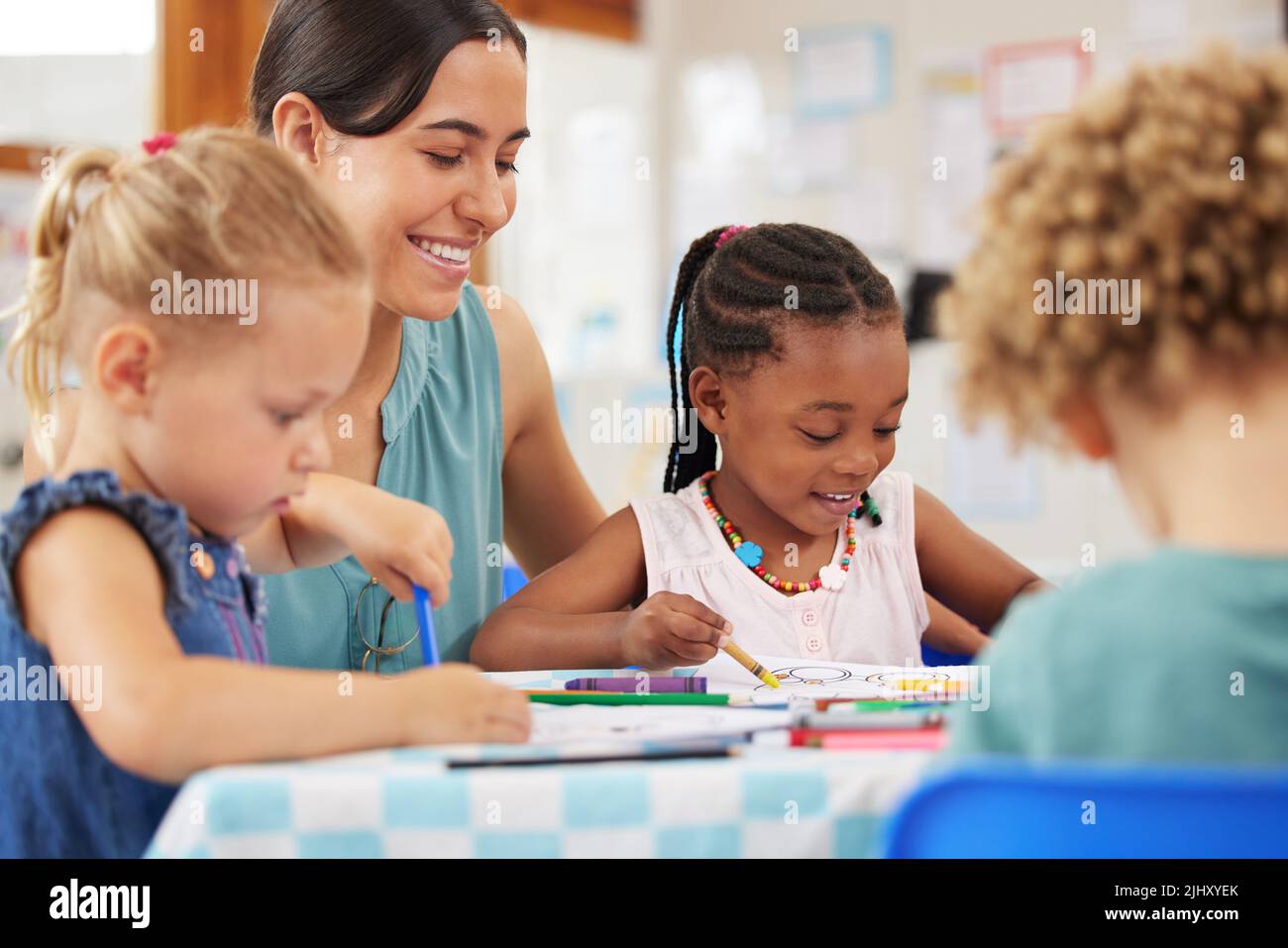 Teaching and kids looking happy while doing activity at kindergarten or ...