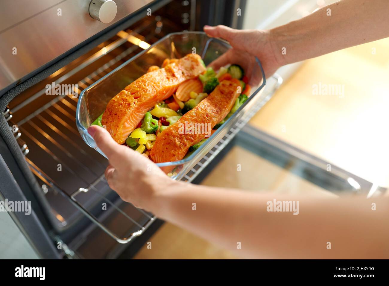Woman opening oven hi-res stock photography and images - Alamy