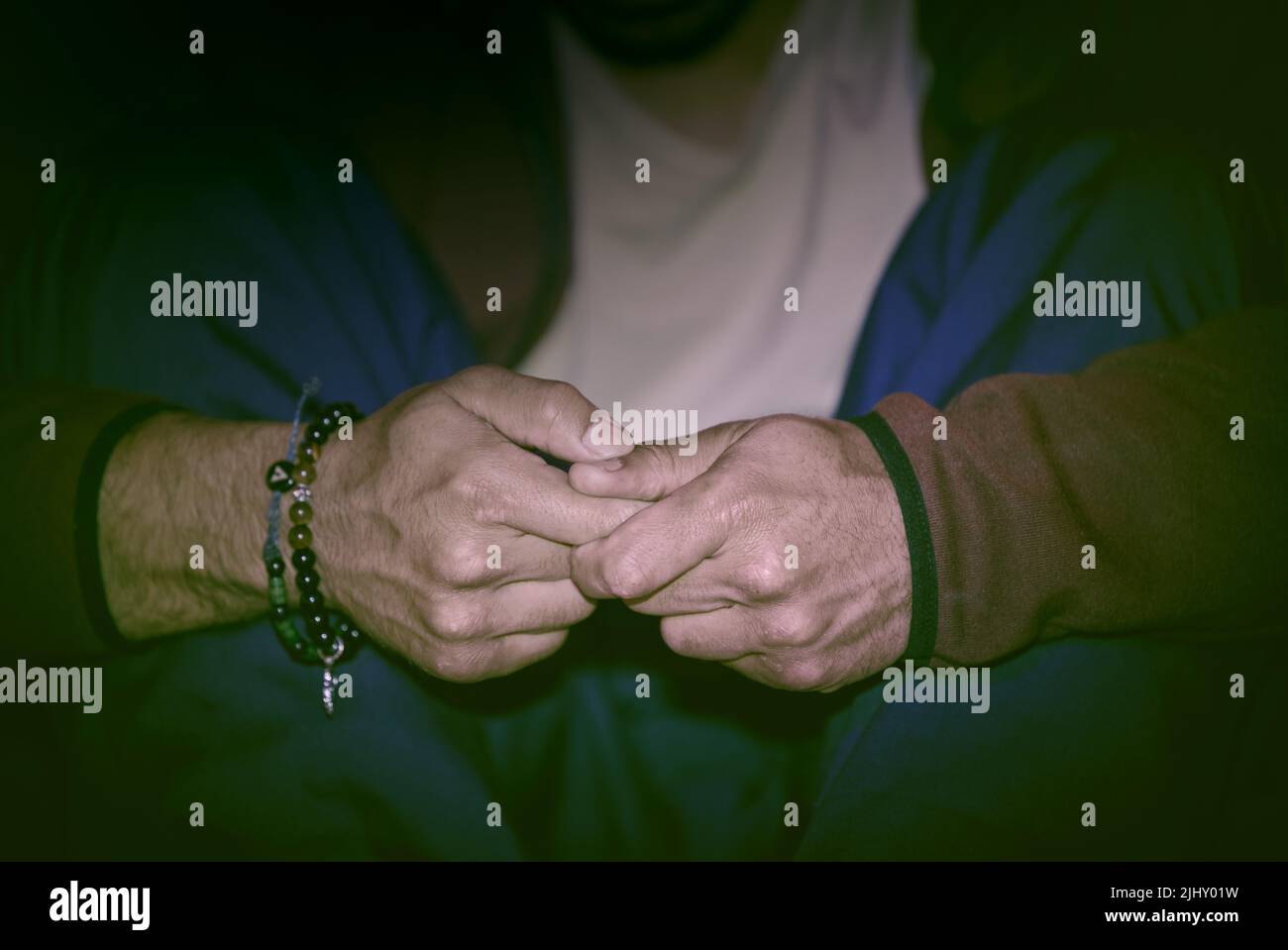 Closeup shot of a man with a mental disorder sitting alone at feeling ...