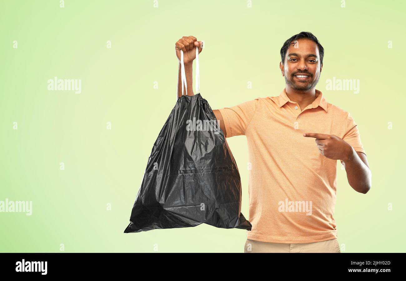 smiling indian man holding trash bag Stock Photo - Alamy