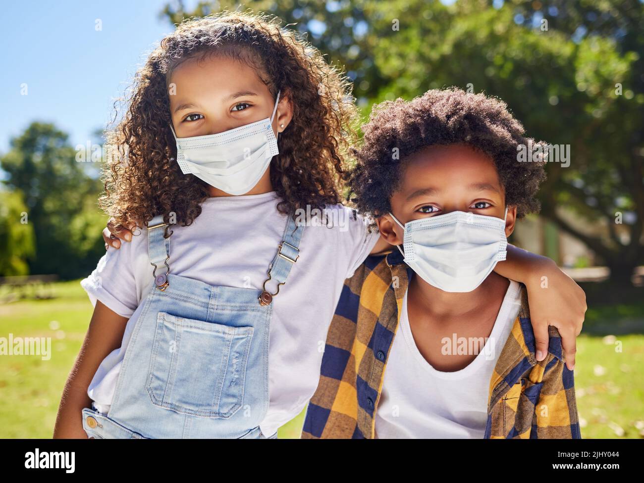 I dont want to go home yet. two friends wearing masks and embracing ...