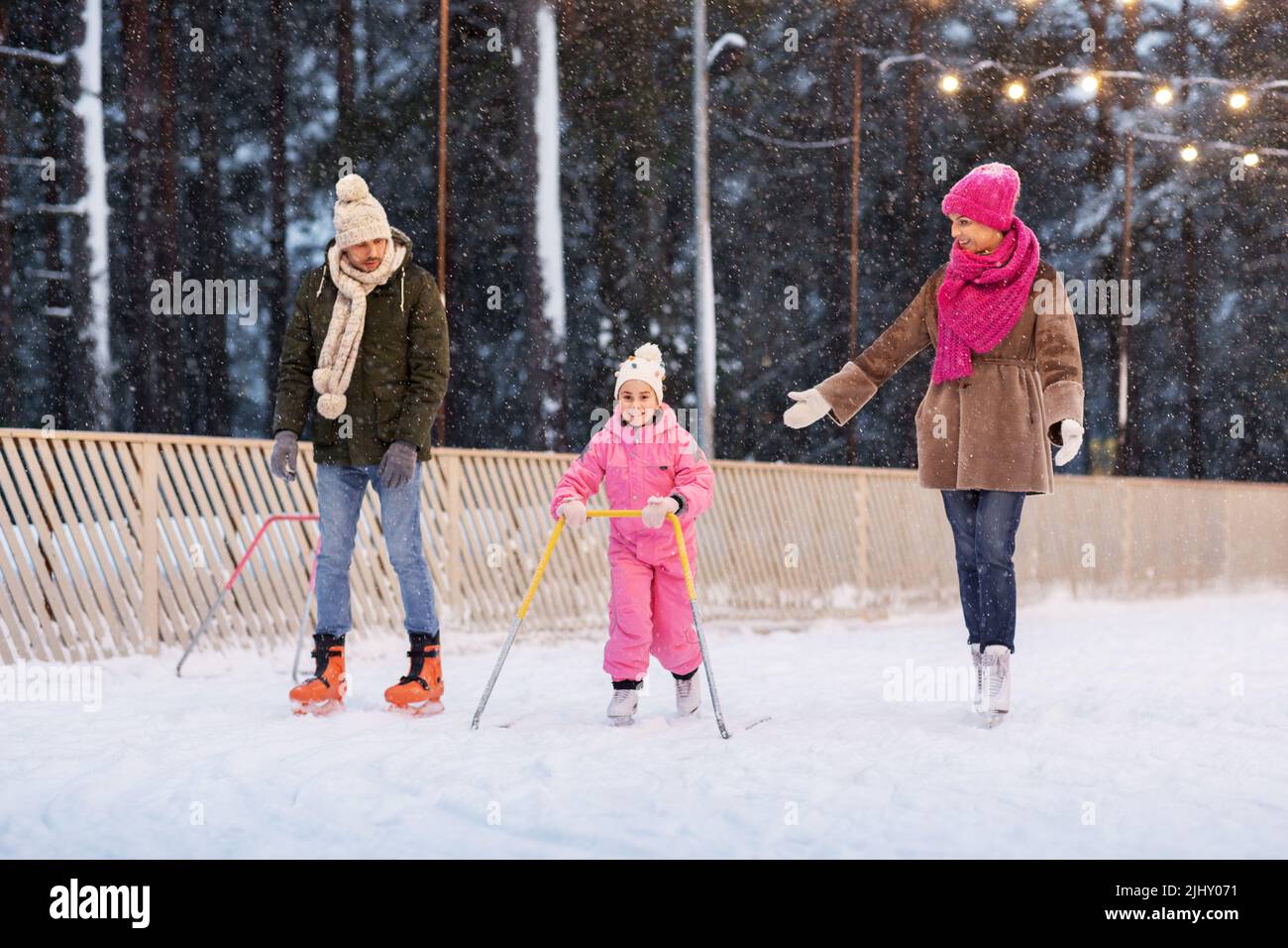 happy family at outdoor skating rink in winter Stock Photo - Alamy