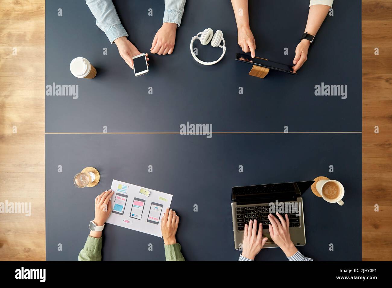 business team with gadgets working at office table Stock Photo - Alamy