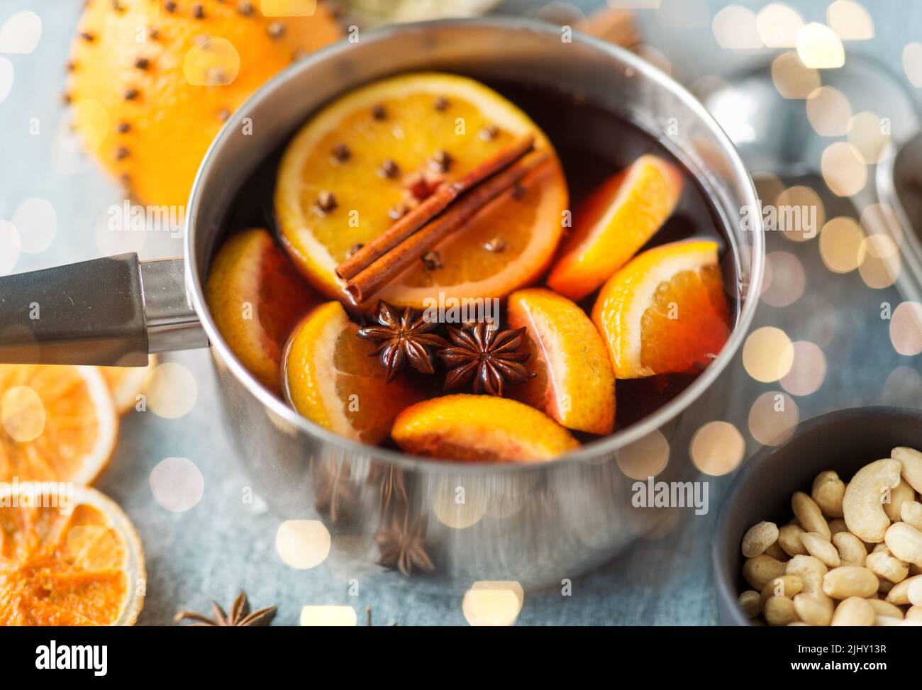 pot with hot mulled wine, orange slices and spices Stock Photo - Alamy
