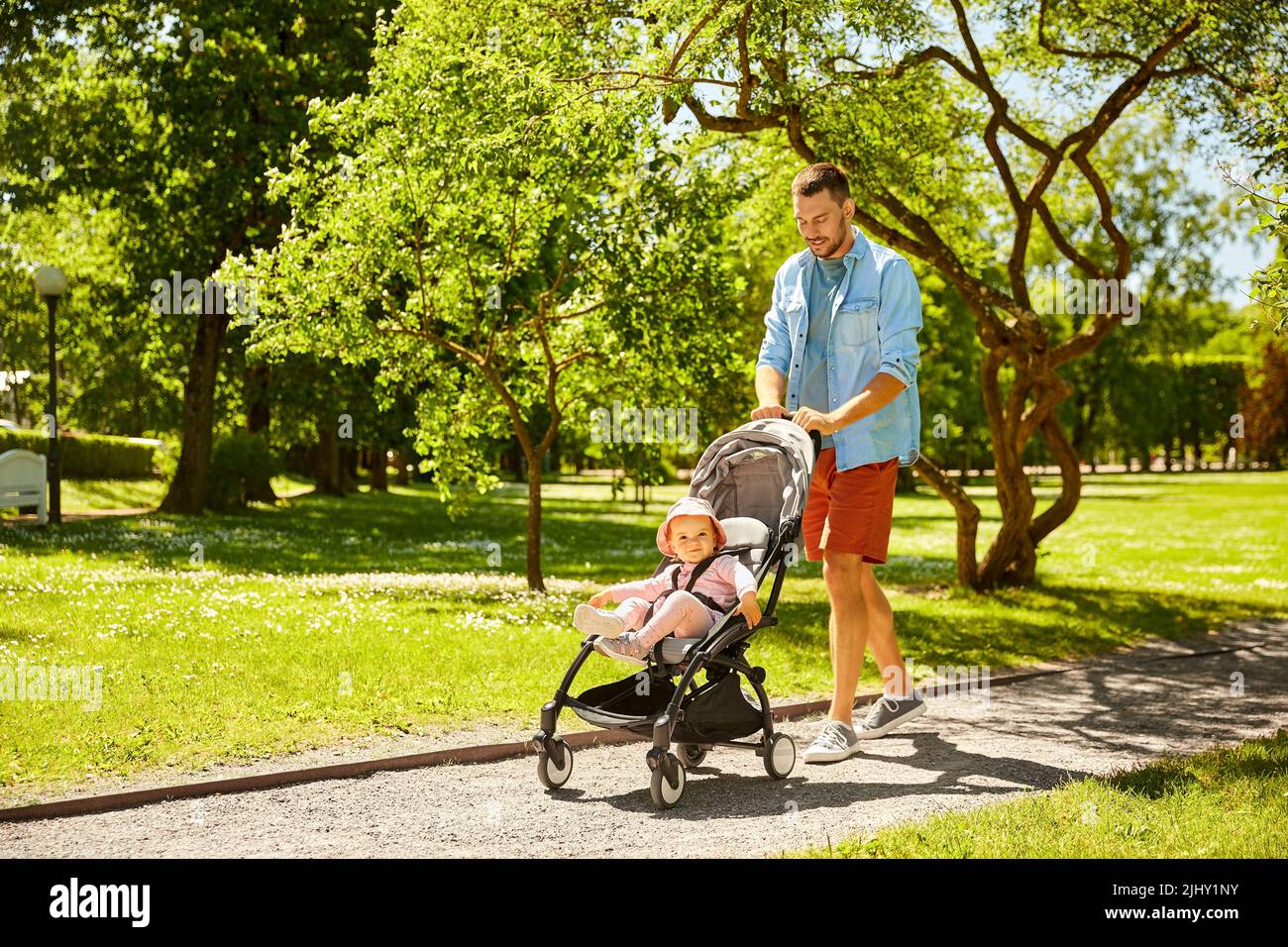 happy father with child in stroller at summer park Stock Photo - Alamy