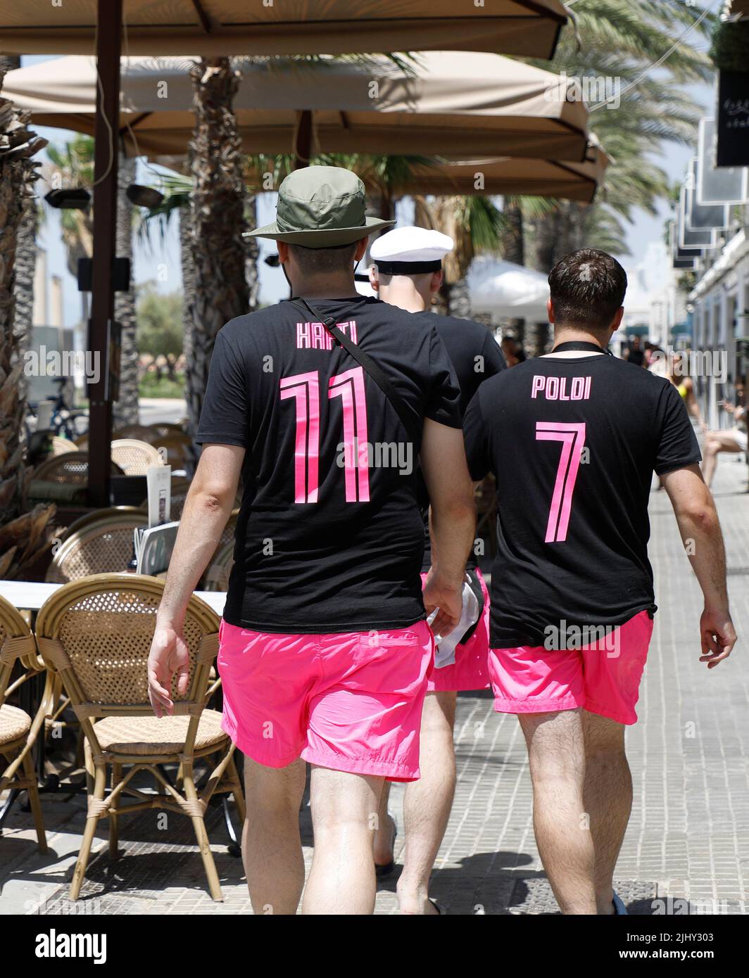 Palma, Spain. 21st July, 2022. Young men walking on the promenade on ...