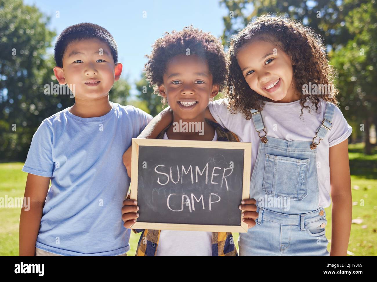 Chilling with the summer camp crew. a group of friends holding a sign ...