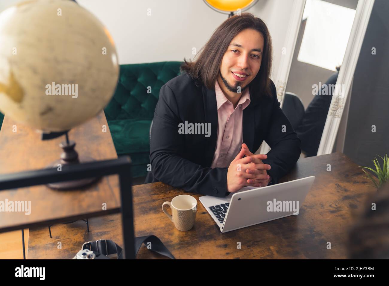 Businessman sitting on a globe hi-res stock photography and images - Alamy