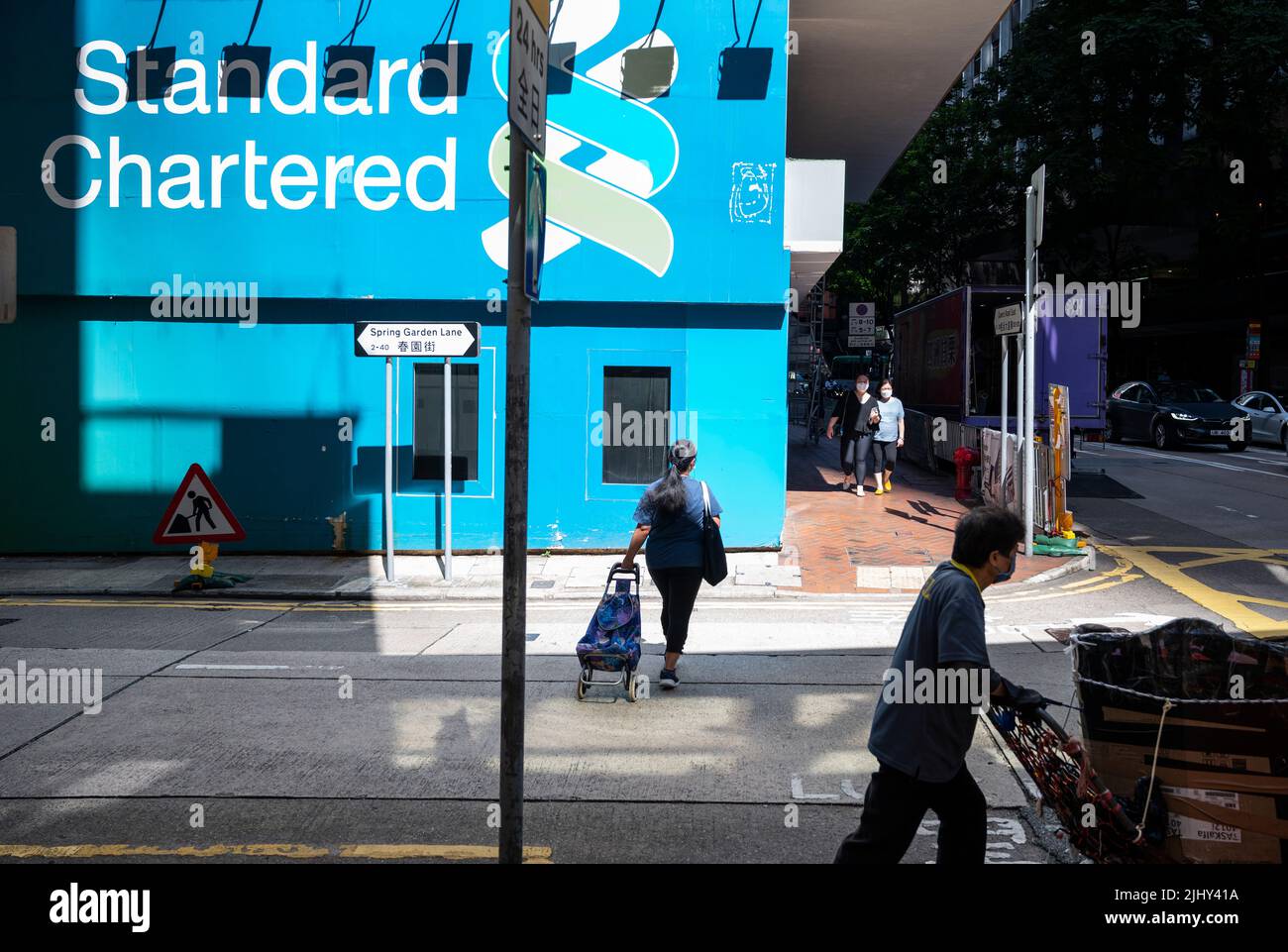 Pedestrians walk past the British multinational banking and financial ...