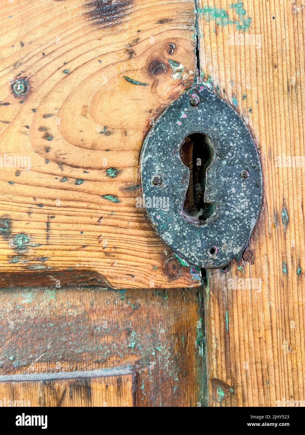 keyhole, closed old textured wooden door with rusty key lock hole. old ...