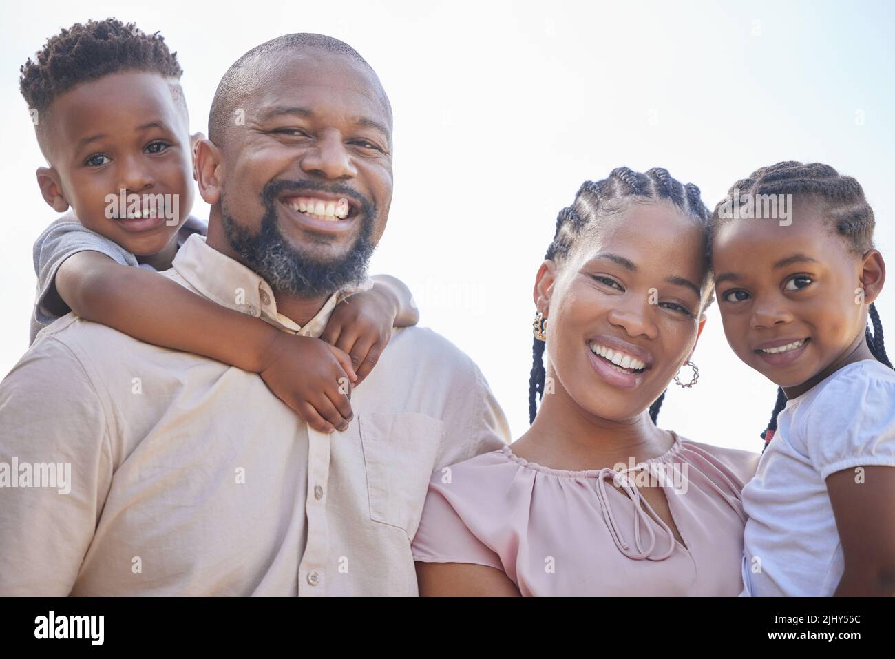 African american couple carrying their little kids outside. Adorable ...