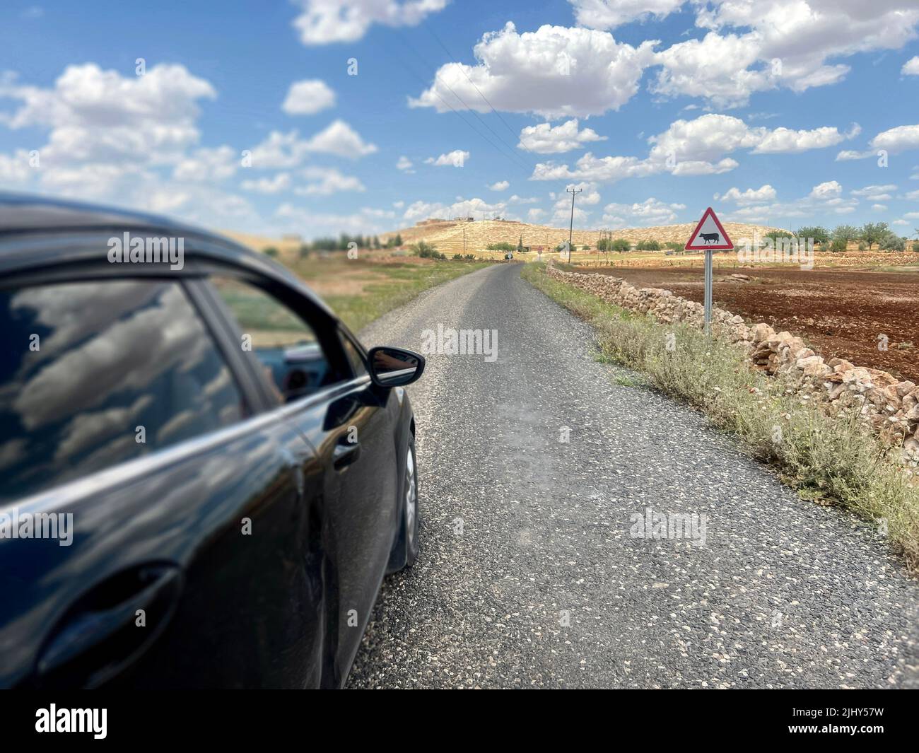 closeup and blurred black car driving on asphalt road in a rural area ...
