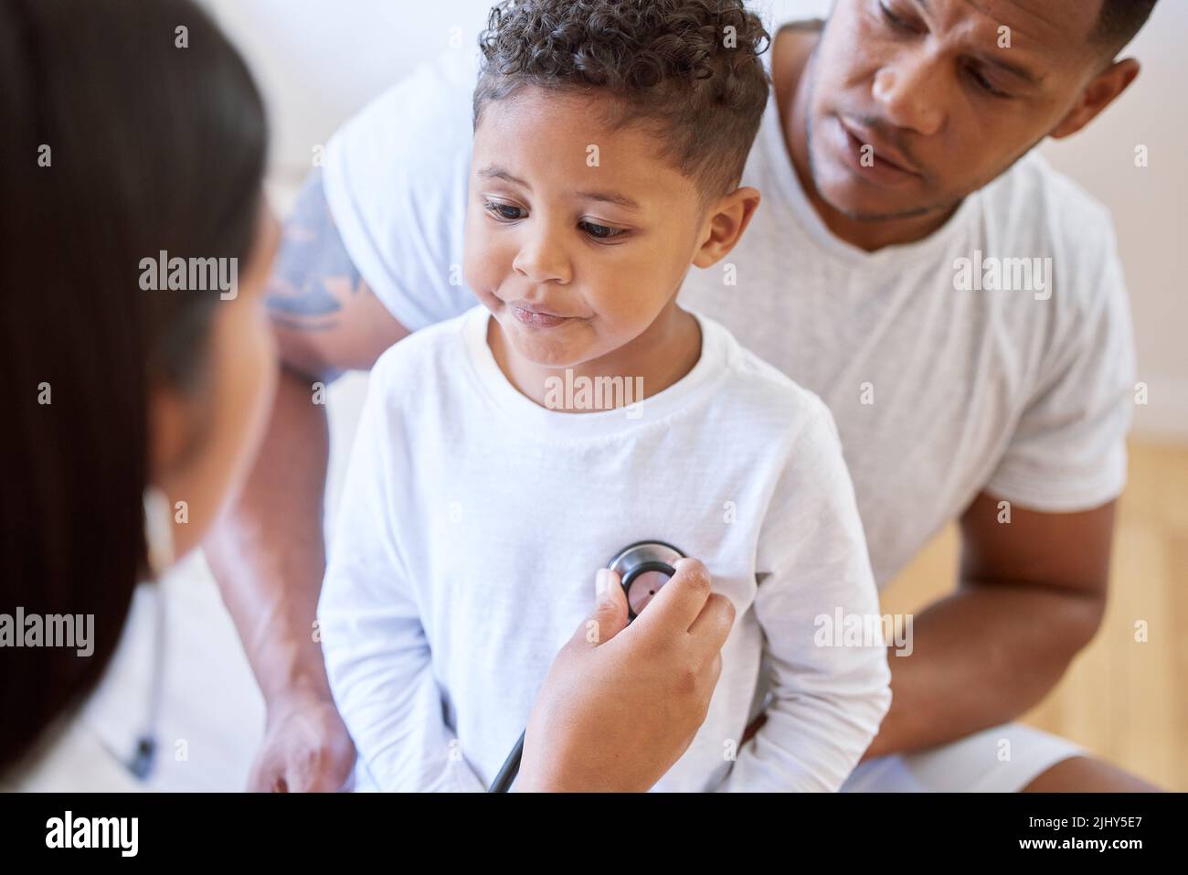Sick child at the doctors office with his mother. Little boy sitting ...