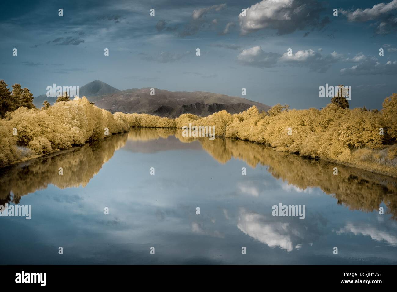 Infrared landscape with reflection of the sky and the clouds of Pinios ...