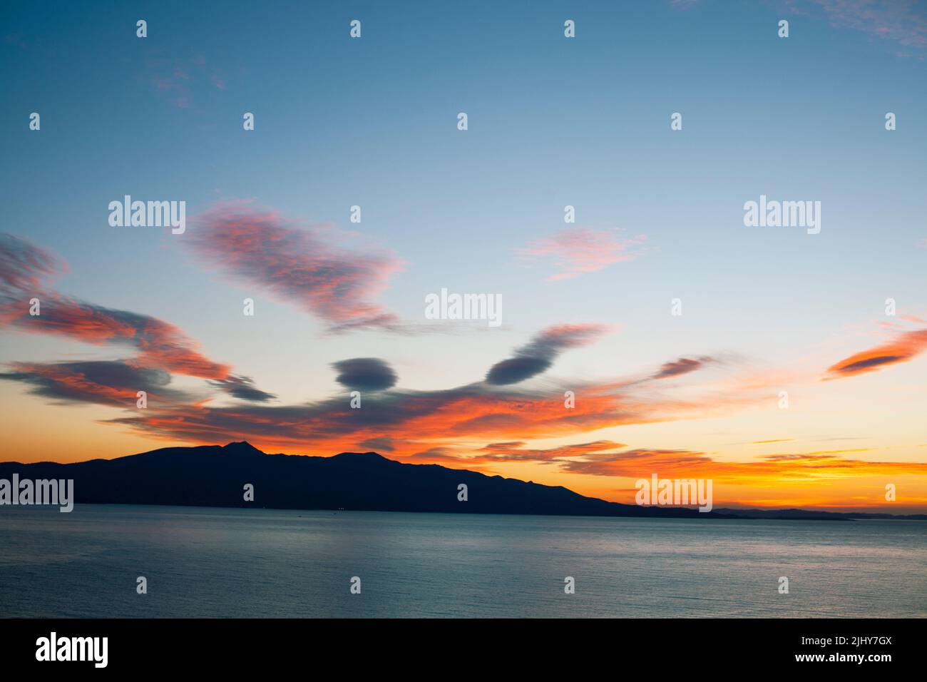 beautiful landscape on sea with sunset, dramatic clouds with red fire ...
