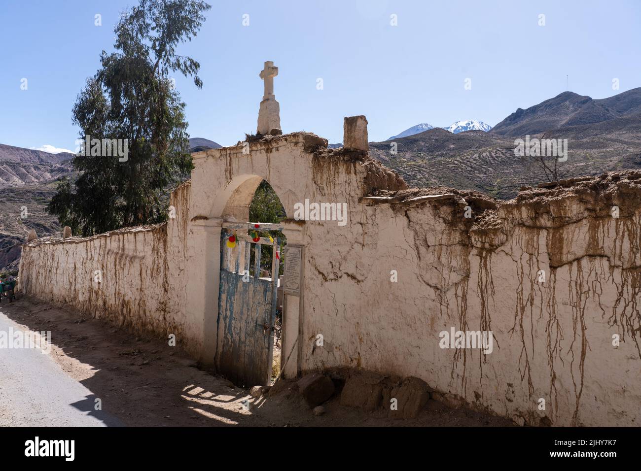 The adobe walls of the village cemetery in the Aymara village of ...