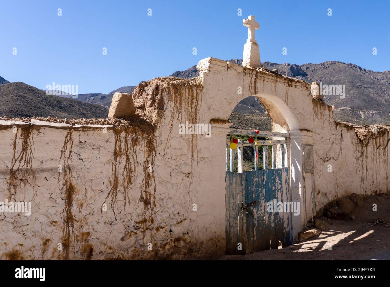 The adobe walls of the village cemetery in the Aymara village of ...