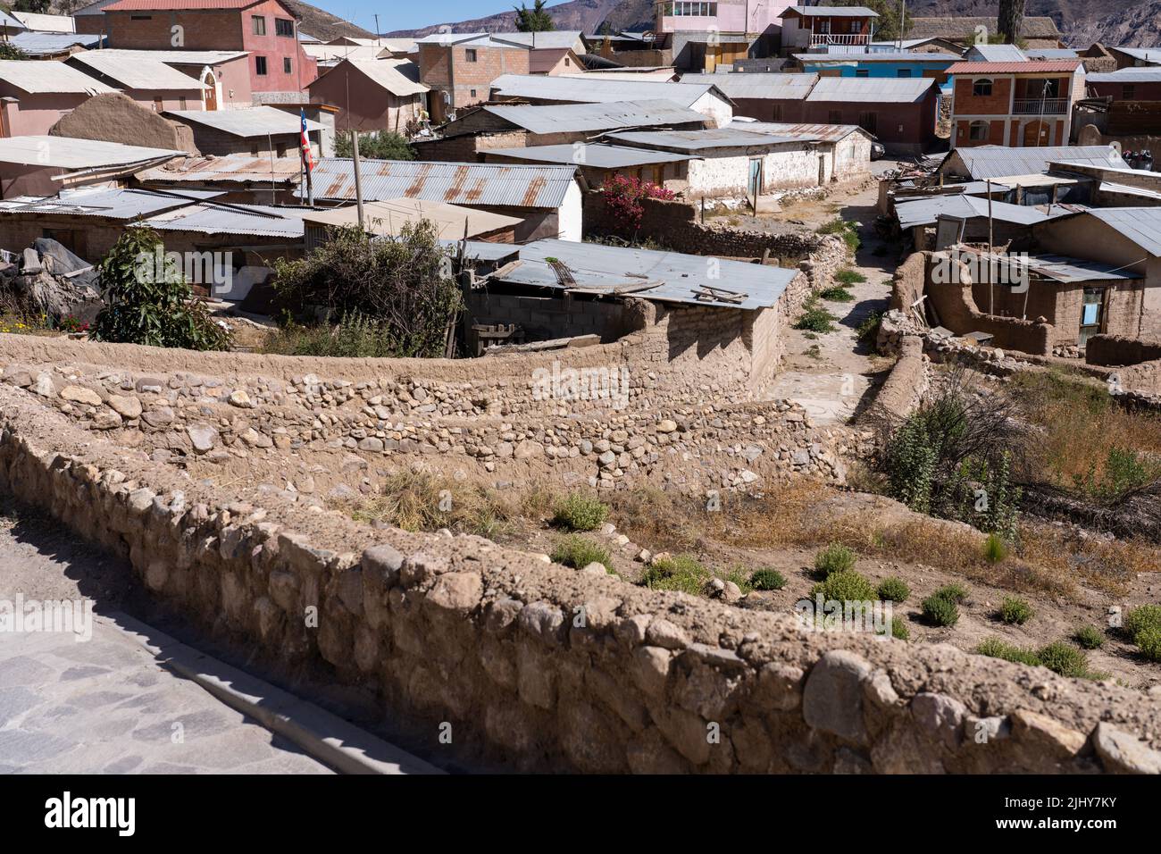 Stone and adobe wallls and tin-roofed dwellings in the Aymara village ...