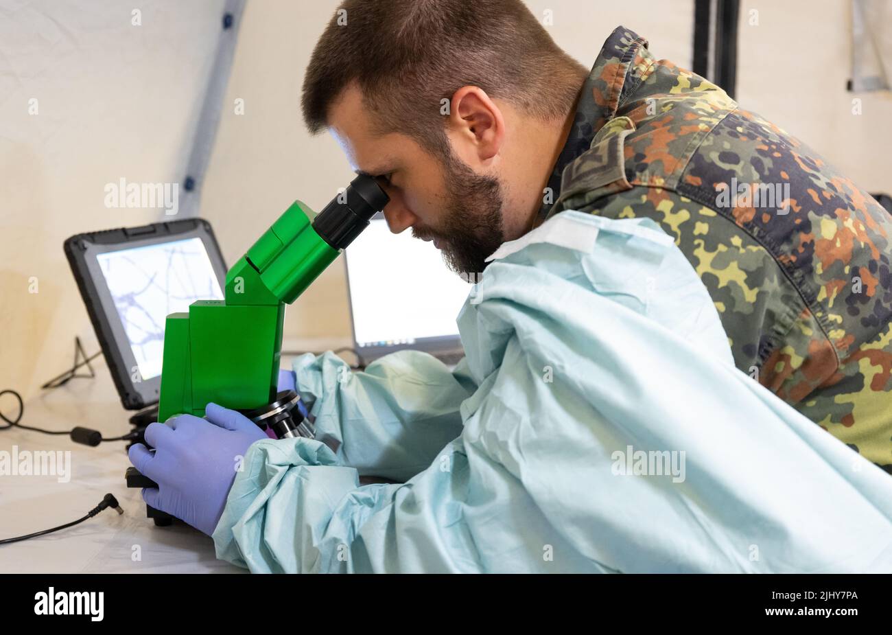 Munich, Germany. 21st July, 2022. A soldier looks through a microscope ...