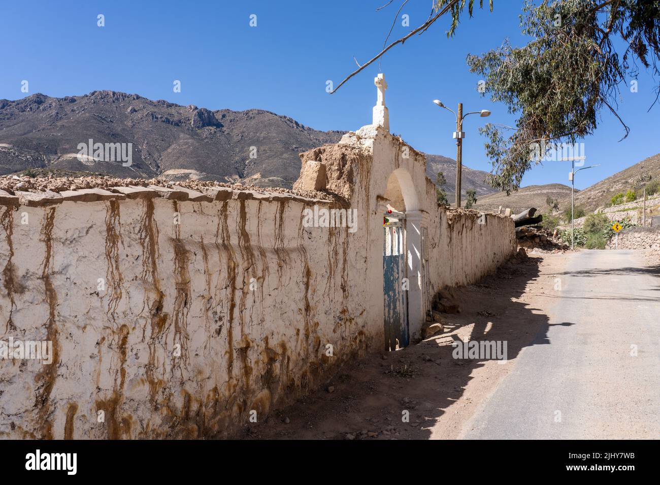 The adobe walls of the village cemetery in the Aymara village of ...