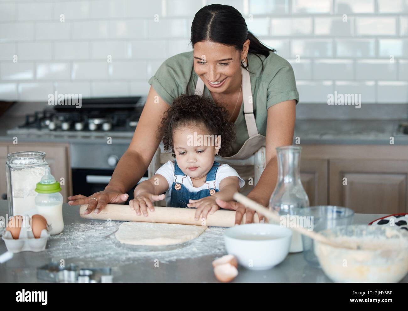 Teach a woman to bake and youll feed a village. a young mom baking with ...