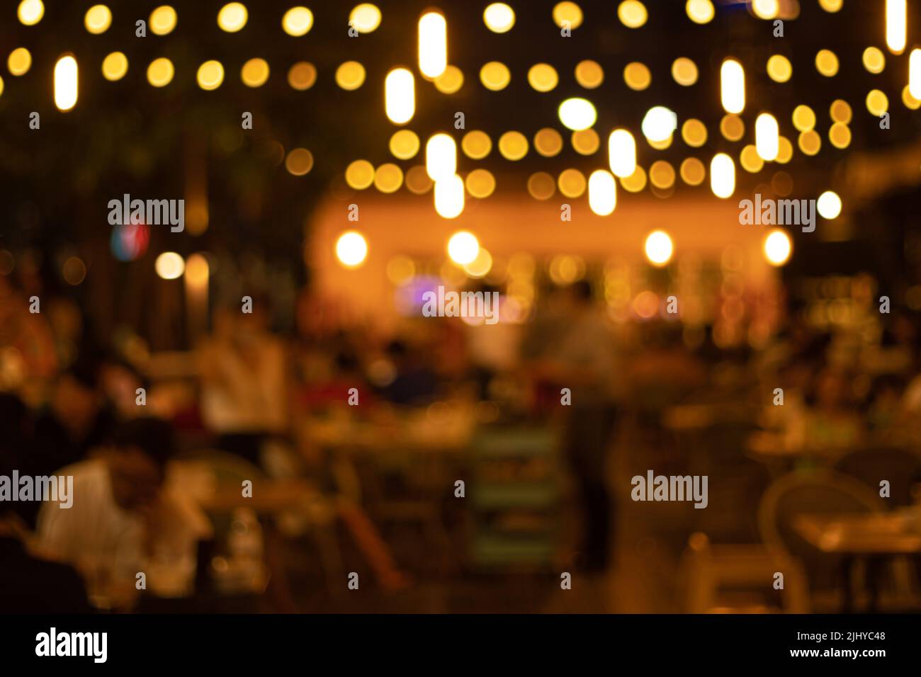 blurred image at the restaurant night time, many people in the ...