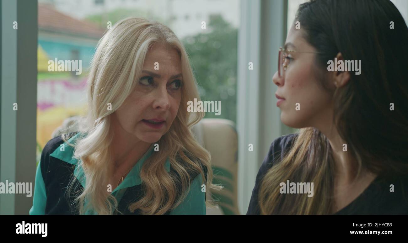 Senior executive female leader coaching younger employee in front of ...