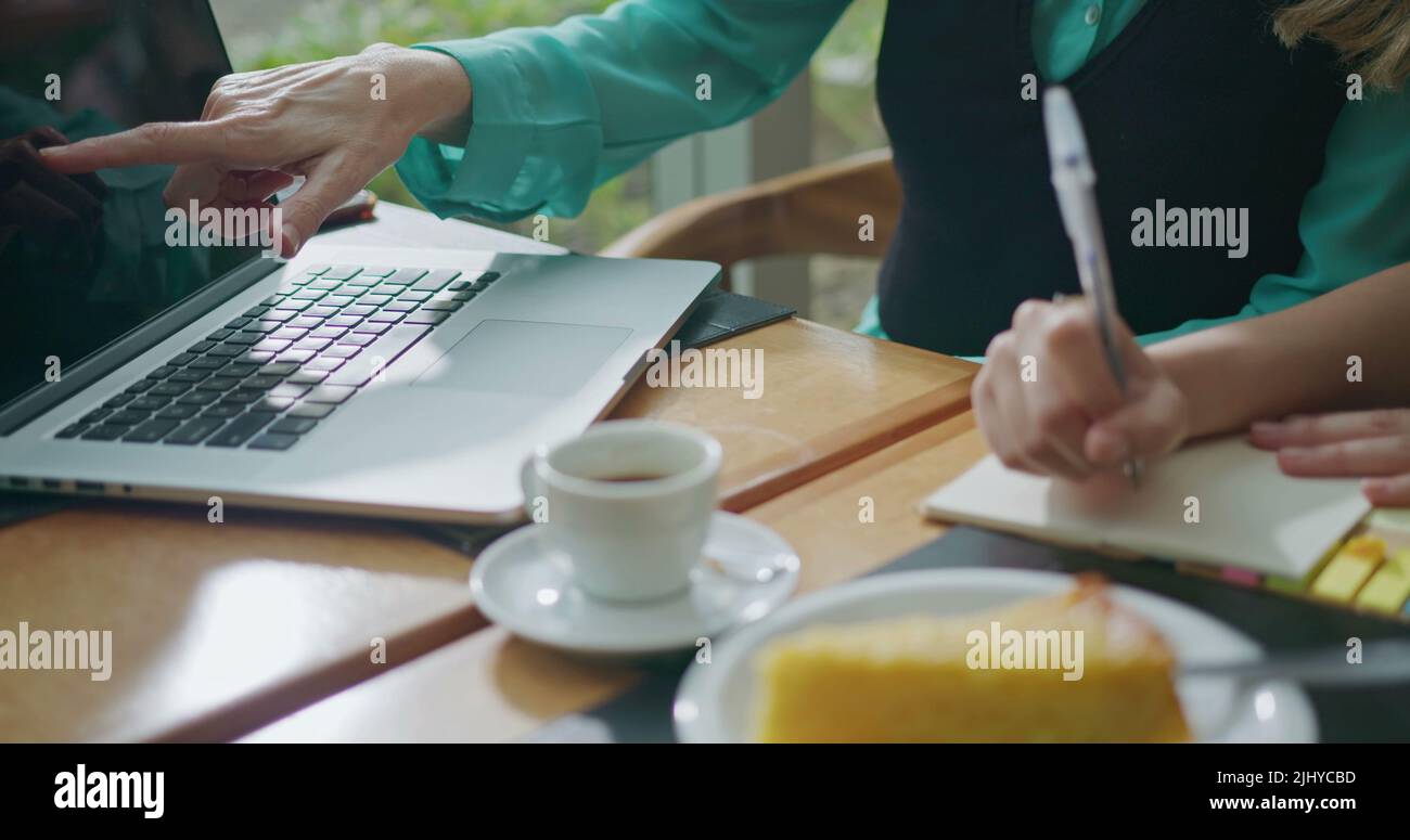 Senior executive female leader coaching younger employee in front of ...