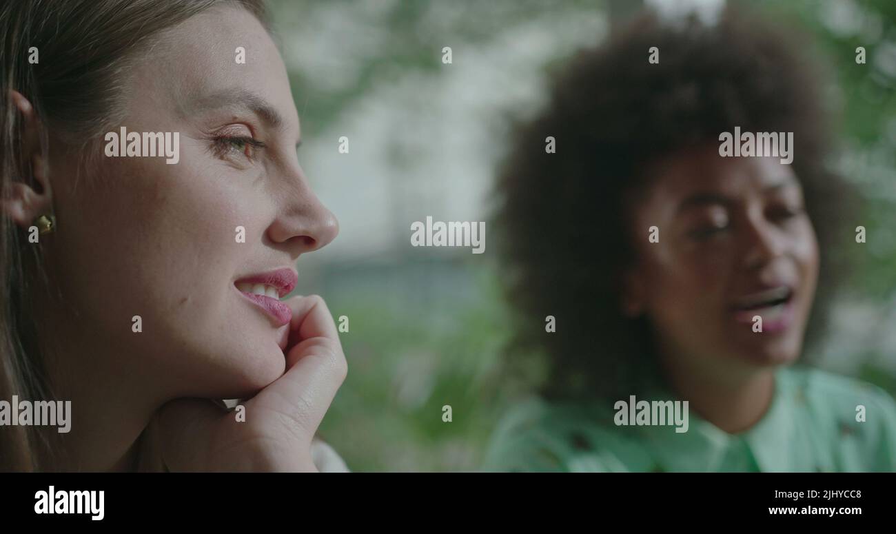 Female diverse friends hanging out together. Closeup of young women ...