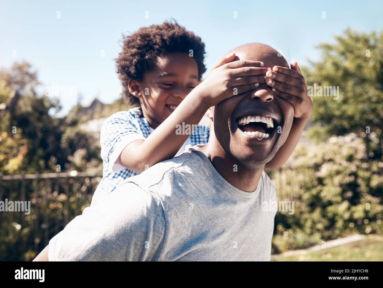 a happy african american man bonding with his young little boy outside ...