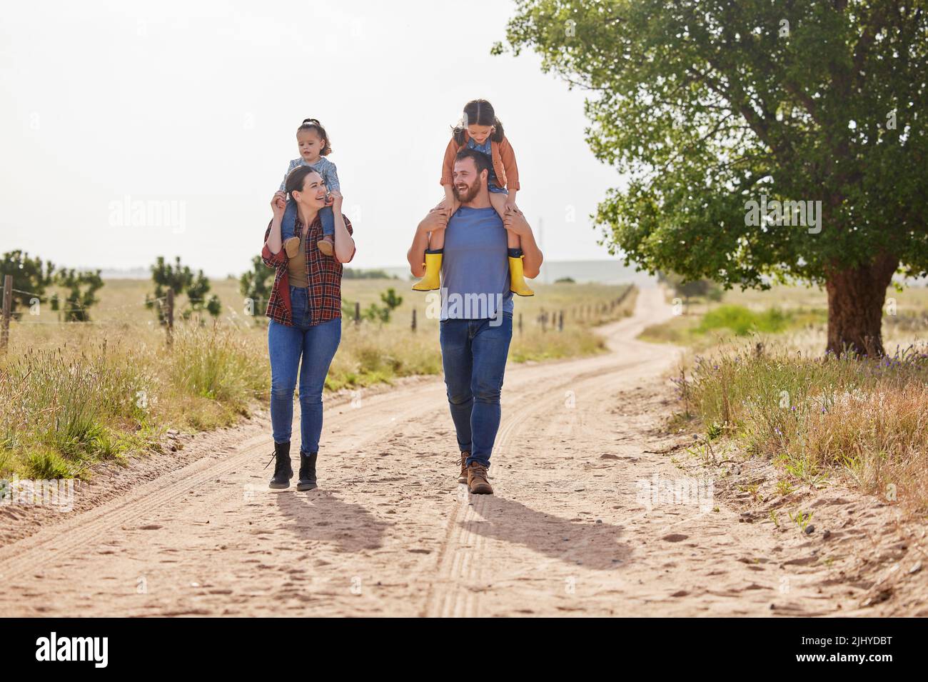 Life is better when spent with family. a couple walking on farm with ...