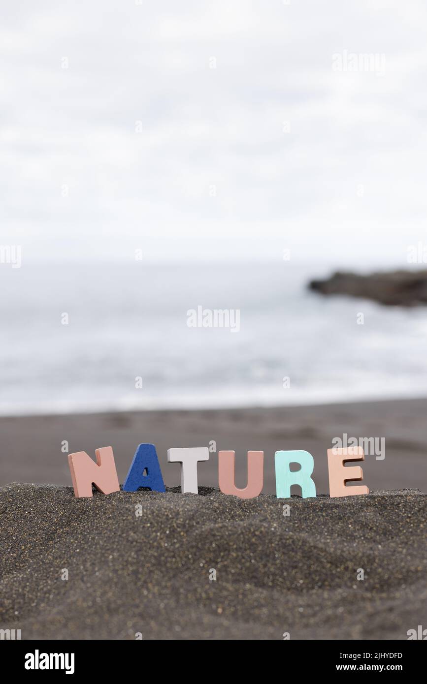 Closeup shot of the word nature made of colourful wooden letters stands ...