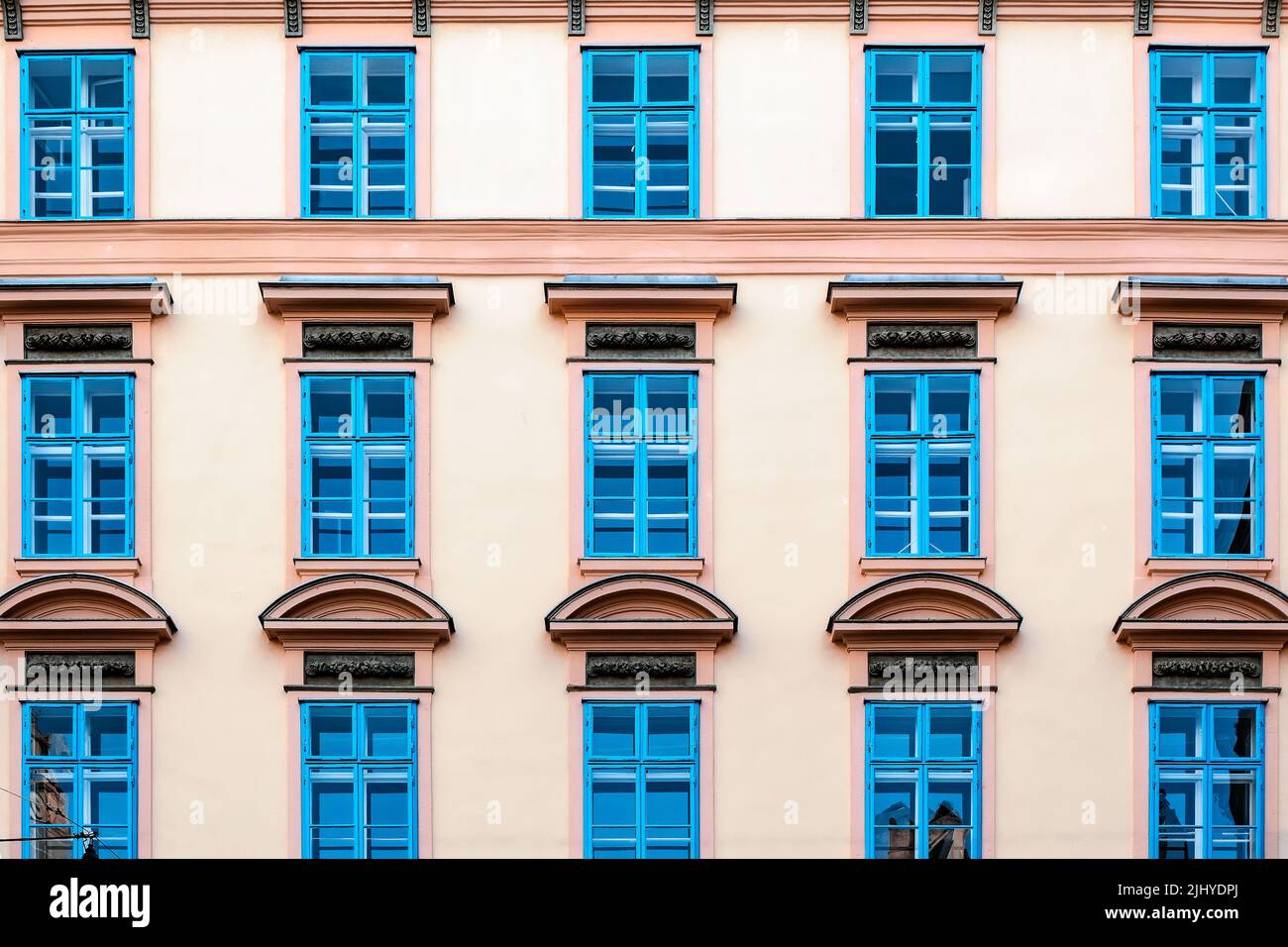 A facade of a residential building with blue windows Stock Photo - Alamy