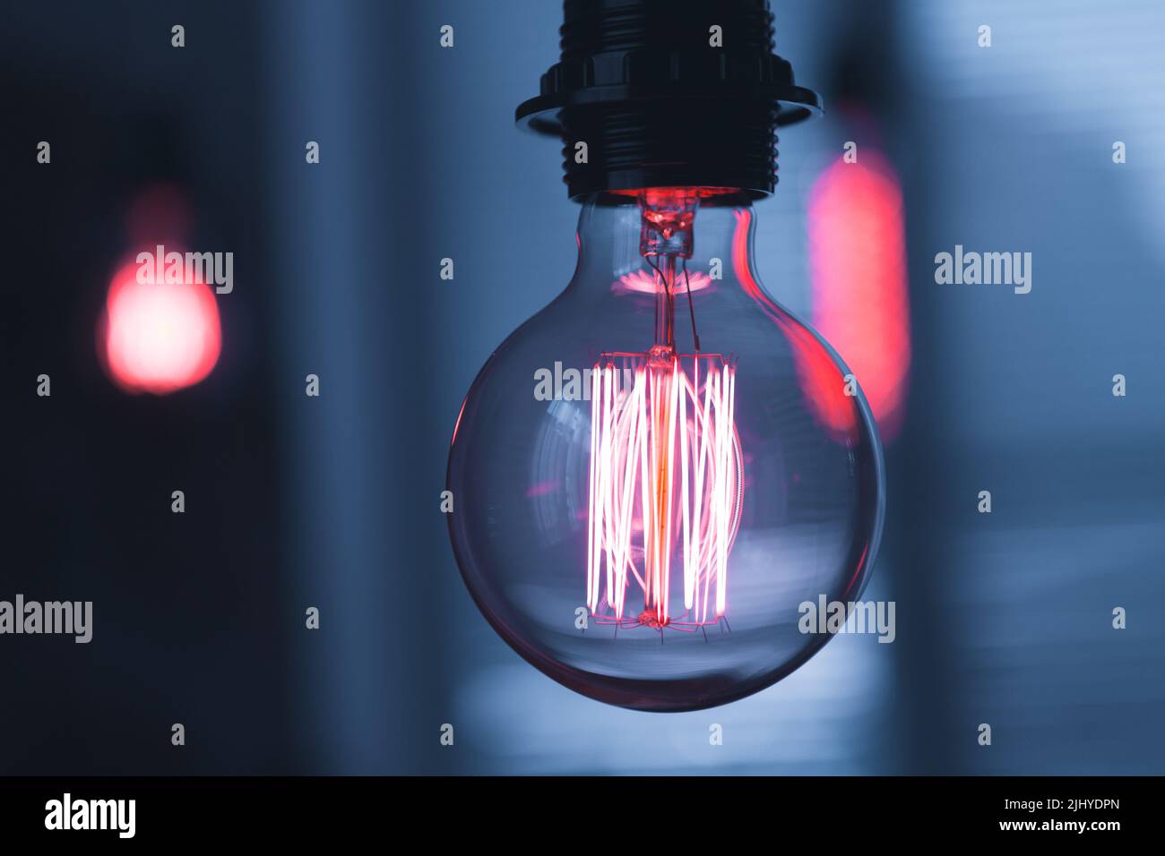 A classic Edison light bulb on dark background with space for text ...