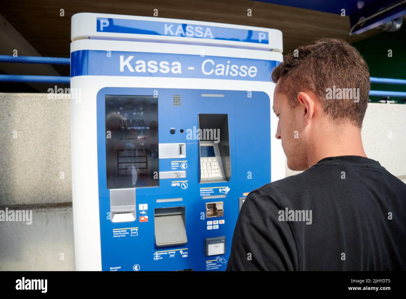 A young male using a ticket vending machine Stock Photo - Alamy