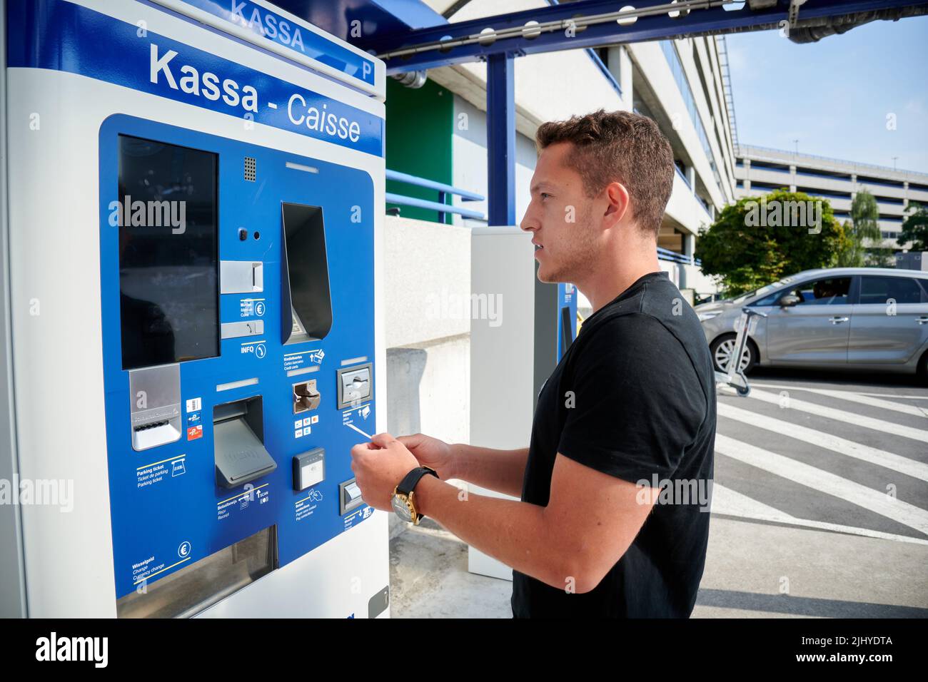 A young male using a ticket vending machine Stock Photo - Alamy