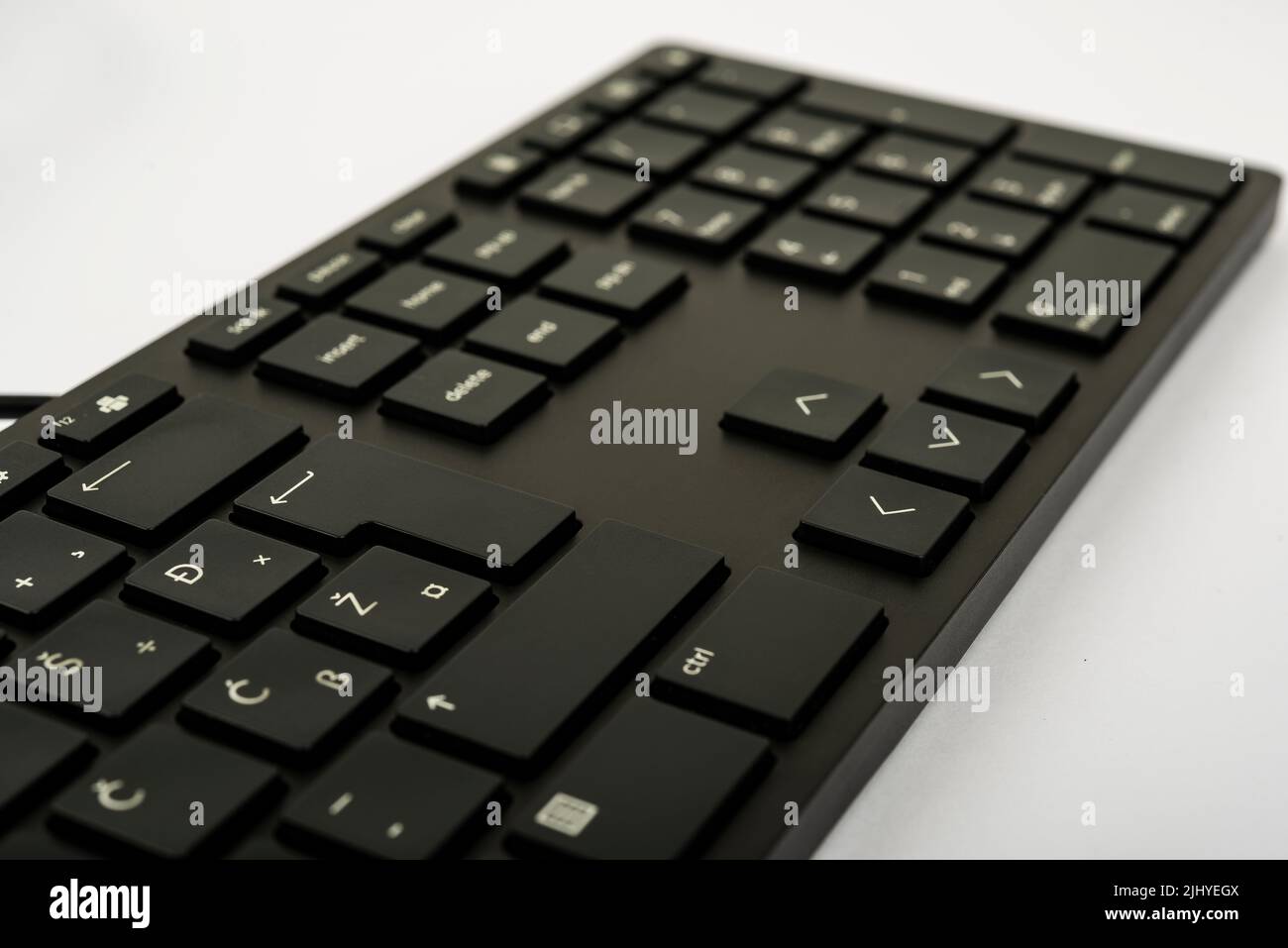 A part of a black computer keyboard isolated on a white background ...