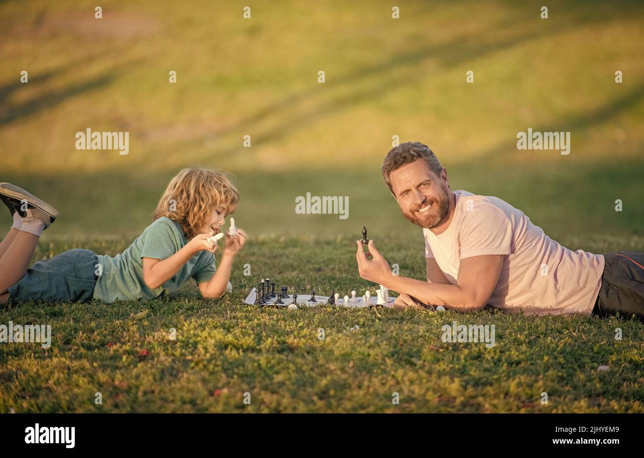 friendship. dad and kid play logic game. father and son playing chess ...