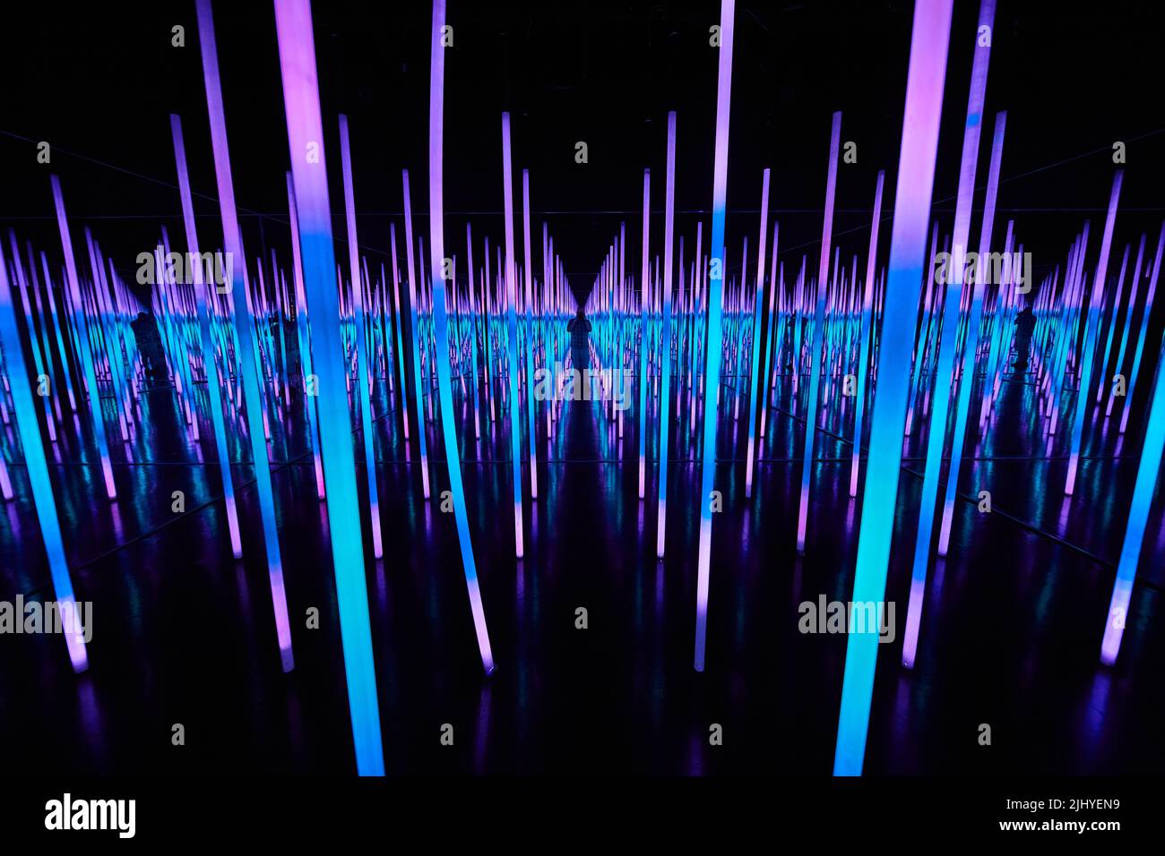 Blue and purple LED light poles in infinity mirror room Stock Photo - Alamy
