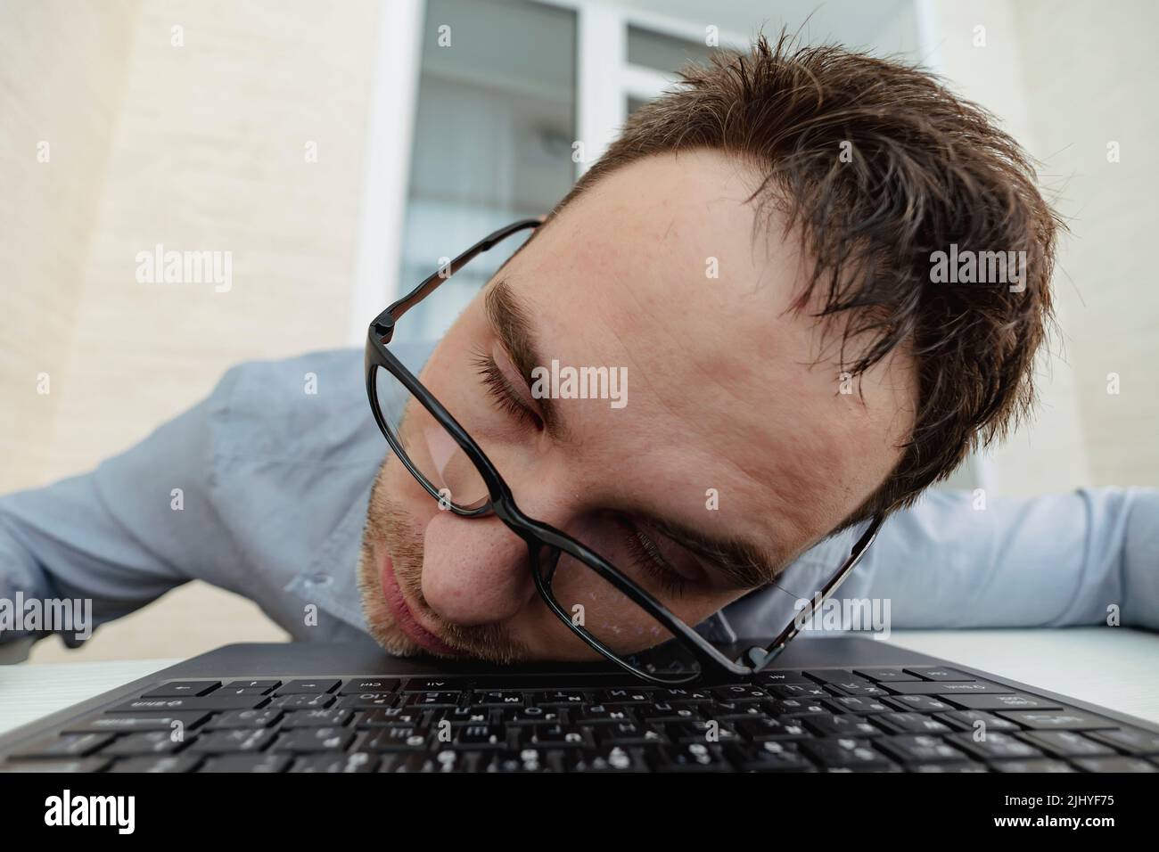 Close-up image of tired Sleepy businessman sleeping on his laptop ...