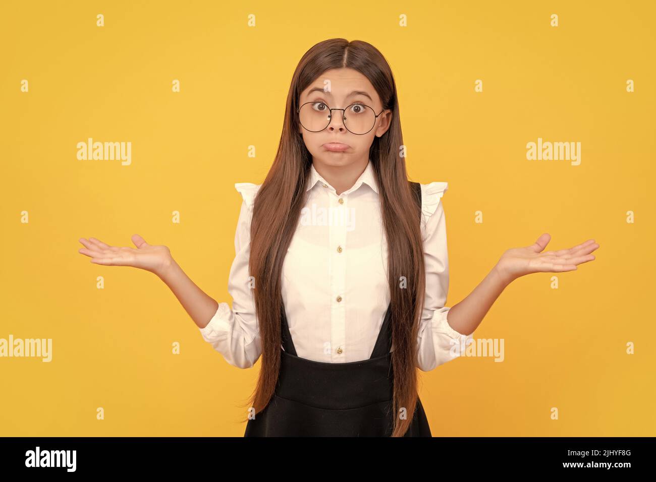 confused child in school uniform and glasses for vision protection ...