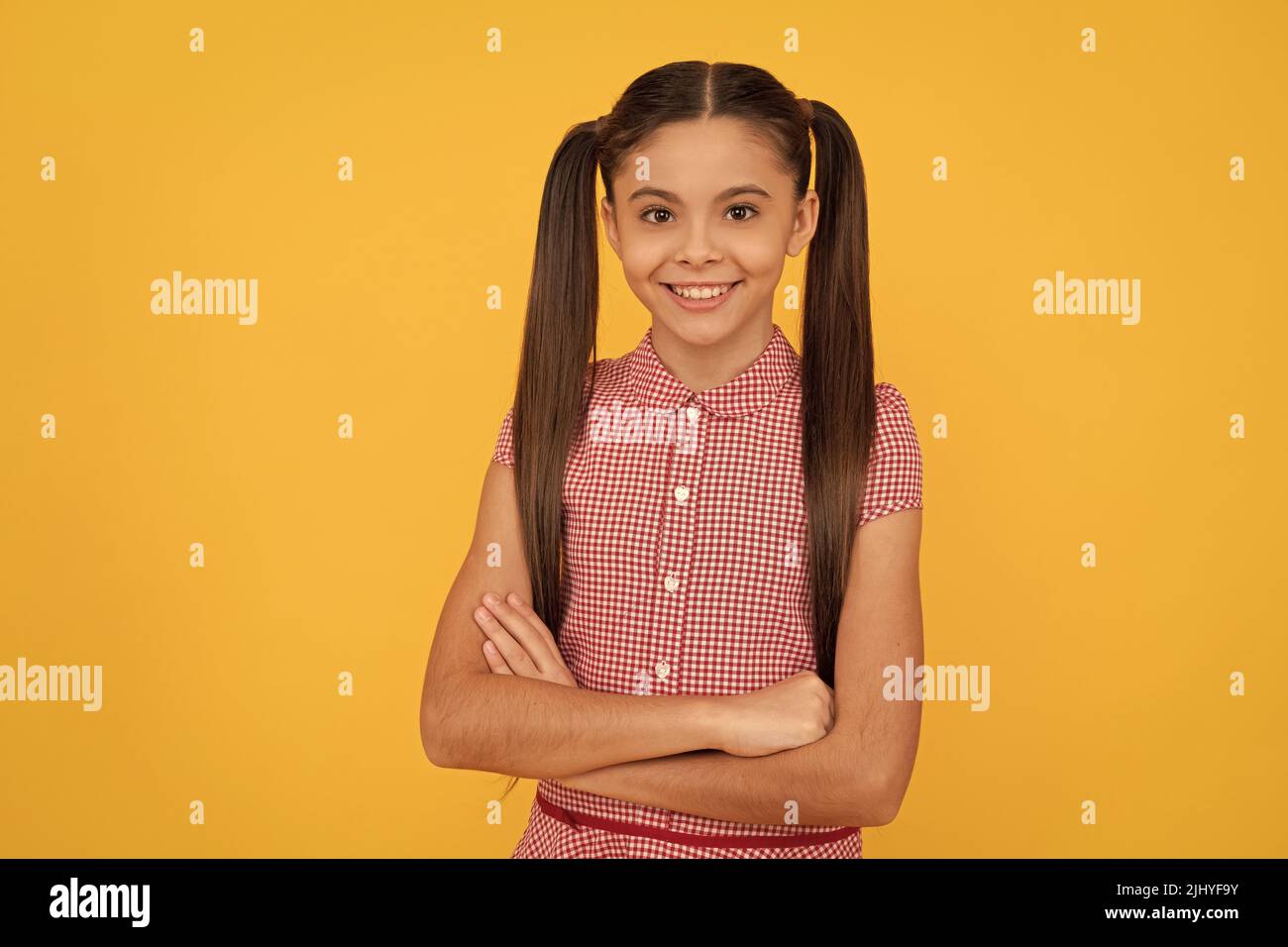 Happy confident child smile holding arms crossed yellow background ...
