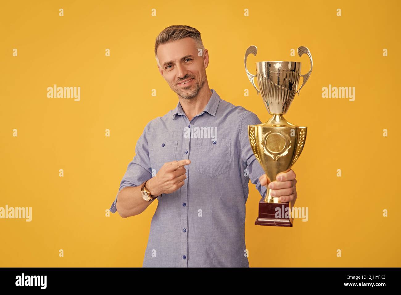 siling man pointing finger on golden cup, achievement Stock Photo - Alamy