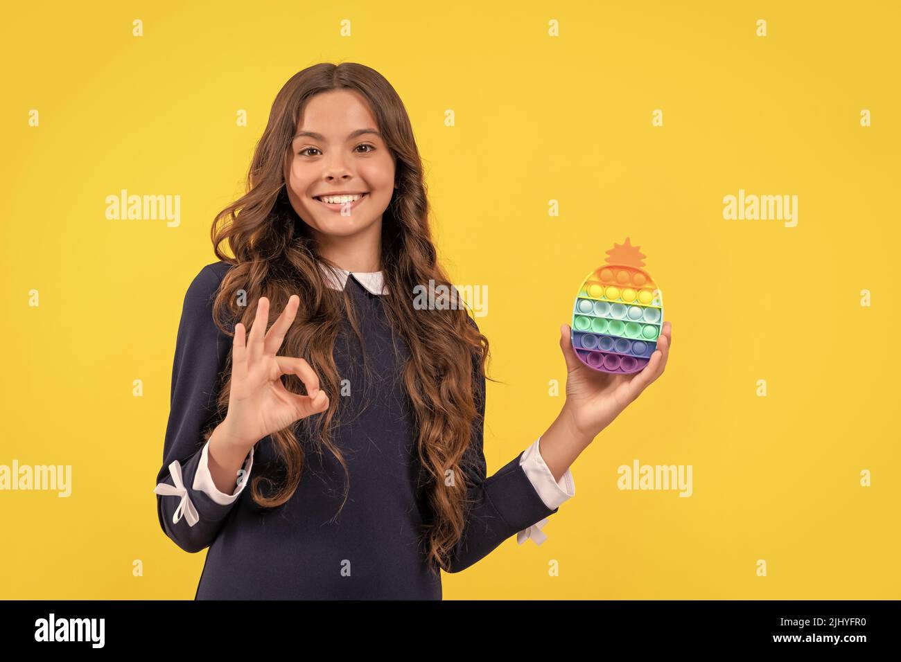 cheerful kid with pop it silicone sensory fidget game show ok gesture ...