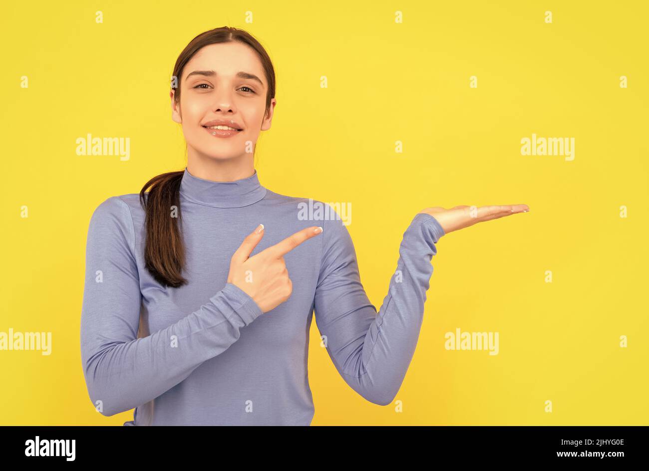 express positive emotions. advertisement. smiling woman pointing finger ...